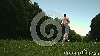 Low Angle View of Sporty Womans Back Running on Grass Stock Footage ...