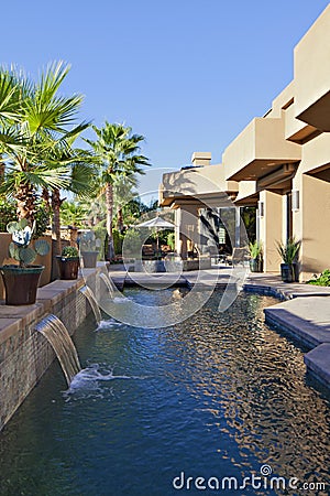 Luxury Villa With Waterfall Feature And Palm Trees Stock Image ...