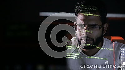 Male Arabic Hacker Hacks Computer in Dark. Computer Code Reflecting on ...