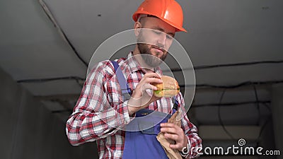 Male Constructor with Protection Helmet Taking from Package Tasty ...