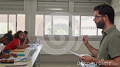 Male Teacher Explaining the Lesson at the University in a Classroom ...