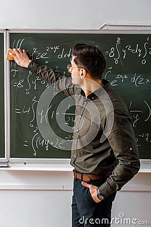 Male Teacher Wiping Mathematical Equations With Sponge From Chalkboard ...
