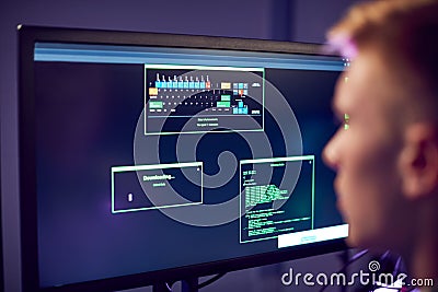 Male Teenage Hacker Sitting In Front Of Computer Screens Bypassing ...