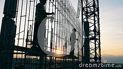 Male Workers are Walking Along the Building Carcass in Progress Stock ...