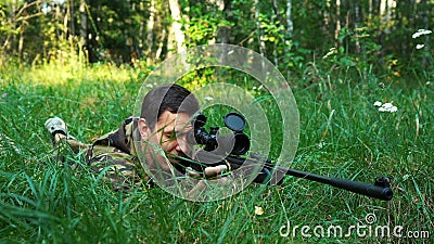 Man Aiming with a Sniper Rifle Lying on the Grass. Stock Video - Video ...