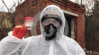 Man in Bio-hazard Suit and Gas Mask Looks Straight into the Camera ...