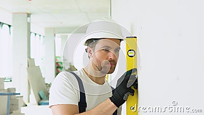 A Man Builder Measures of the Vertical Deviation of Plasterboard Wall ...