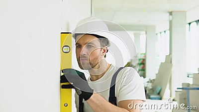 A Man Builder Measures of the Vertical Deviation of Plasterboard Wall ...