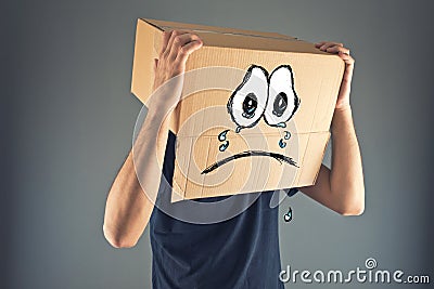 Man With Cardboard Box On His Head And Sad Face Expression Stock Photo ...
