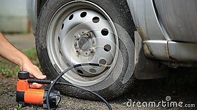 Man Compressor Pump Pumps the Front Wheel of the Car. Stock Footage ...