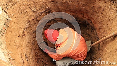 Man Digger Digs a Well by Hand Stock Video - Video of digging, blue ...