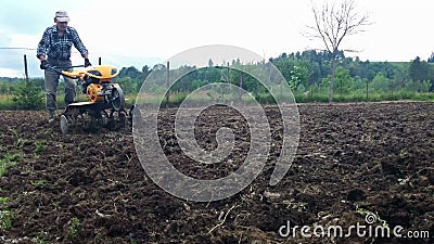 Man Plowing Field Using a Cultivator, Garden Preparation Stock Footage ...