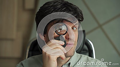 Man See through Magnifying Glass. Male Taking a Magnifying Glass and ...