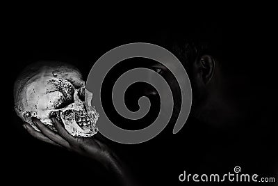 Man In Shadow Stare Human Skull That Hold In Hand Royalty-Free Stock ...