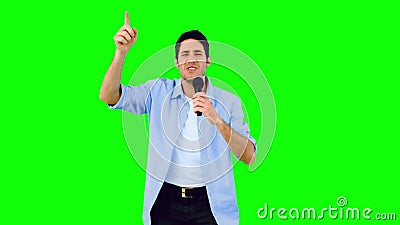 Man Singing into Microphone and Dancing on Green Screen Stock Video ...