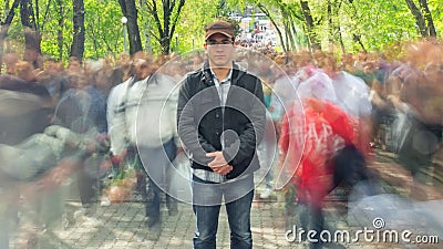 Man Standing Alone in Blurred Crowd, on Background Green Trees. Time ...