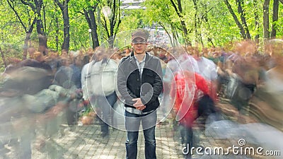 Man Standing Alone in Blurred Crowd, on Background Green Trees. Time ...