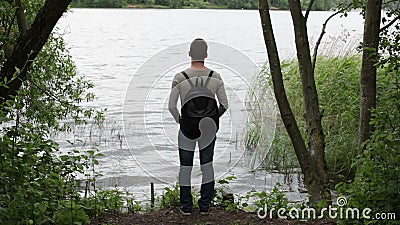Man Standing Along on a Bank of a River Stock Footage - Video of river ...