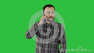 A Man is Talking on the Phone and Smiling on a Green Screen, Chroma Key ...