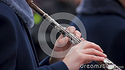 Man in Uniform Skillfully Playing Oboe Accompanied by Brass Band ...