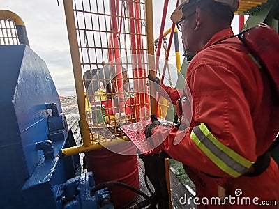 Marine Crew Operate Tugger Winch During Anchor Handling Operation At ...