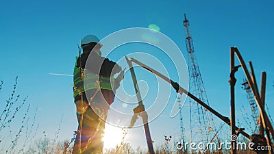 Mature Engineer Working on Smartphone with Satellite Dish Telecom ...