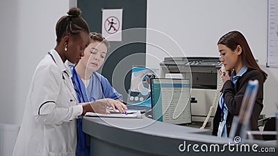 Medical Assistant and Doctor Analyzing Report Papers at Reception ...