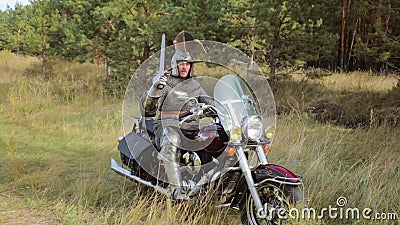 A Medieval Knight in Full Armor Sits on a Motorcycle Against the ...