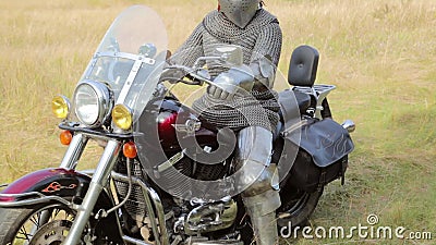 A Medieval Knight in Full Armor Sits on a Motorcycle Against the ...