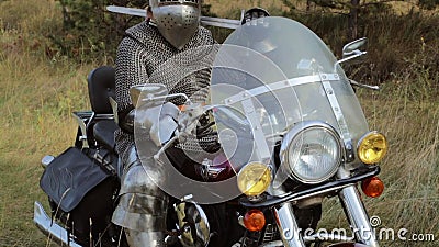 A Medieval Knight in Full Armor Sits on a Motorcycle Against the ...