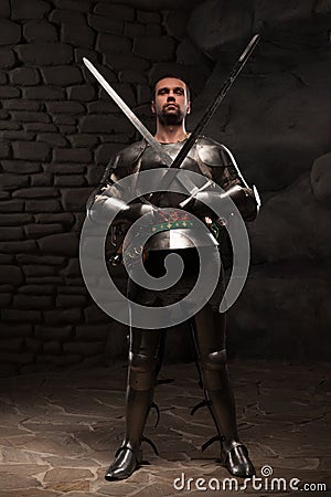 Medieval Knight Posing With Two Swords On In A Stock Image ...