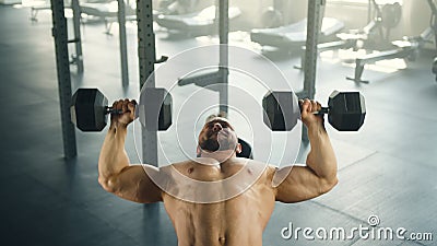 Medium Shot of Man with Bare Muscular Torso Doing Dumbbell Bench Press ...