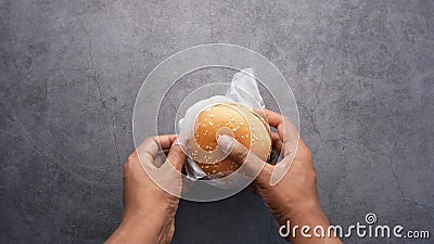 Men Removing a Paper Packet from a Beef Burger Stock Video - Video of ...