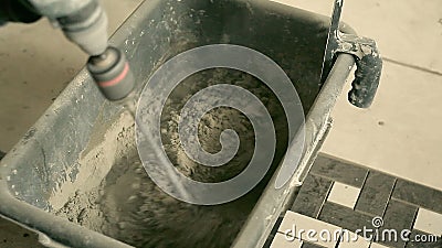 Mixing mortar in a bucket stock footage. Video of accessory - 115345424
