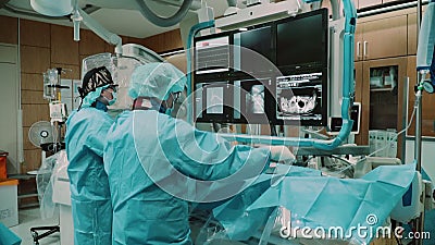 Operating Room In Which Doctors Perform Surgery Looking Into Monitors ...