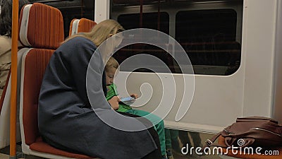 Mother and Child Using Cell in Moving Subway Train Stock Video - Video ...
