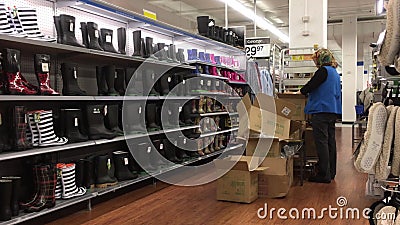 Motion of Worker Stocking Shoes on Display Rack Inside Walmart Store ...