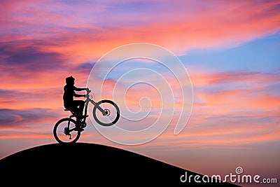 Mountainbiker Doing Wheelie In Sunset Sky On Hill Stock Photography ...