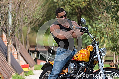 Muscular Man And Motorcycle Stock Photo - Image: 49608724
