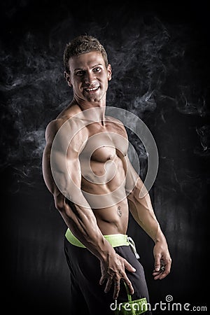 Muscular Young Bodybuilder In Relaxed Pose Stock Photo | CartoonDealer ...