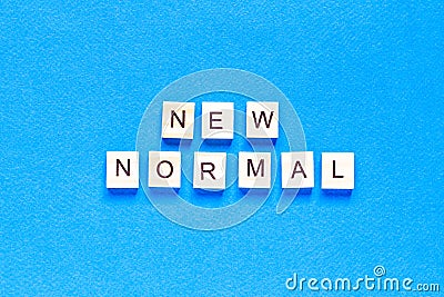NEW NORMAL Word On Wooden Alphabet Cube. New Normal Concept. Top View ...