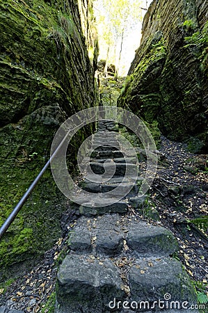 A Number Of Steps Of Leading Upwards In Between Tall Rock Structures ...