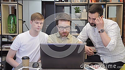 In the Office, Three Men Work Quietly in Front of One Computer. Stock ...