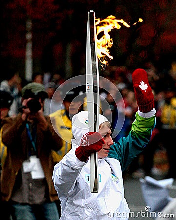 Olympic Torch Bearer Waves To Crowd Editorial Photo - Image: 13692471