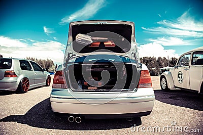 Open The Trunk Of A Silver Car That Stands On The Street. In The Trunk ...