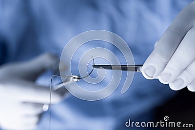 Operator Holding Half Circle With Forceps During Operation. Medical ...