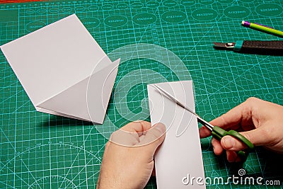 Origami Project On White Paper With Cutter And Scissors Stock Photo ...