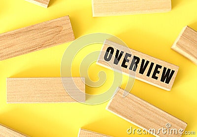 OVERVIEW Text Written On A Wooden Blocks On A Yellow Background. Stock ...