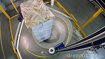 Packing Boxes in Plastic Film. Box Stretch Wrapping Machine. Pallet ...