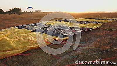 Parachute Lying on the Ground in the Sunset Rays of the Sun on the ...